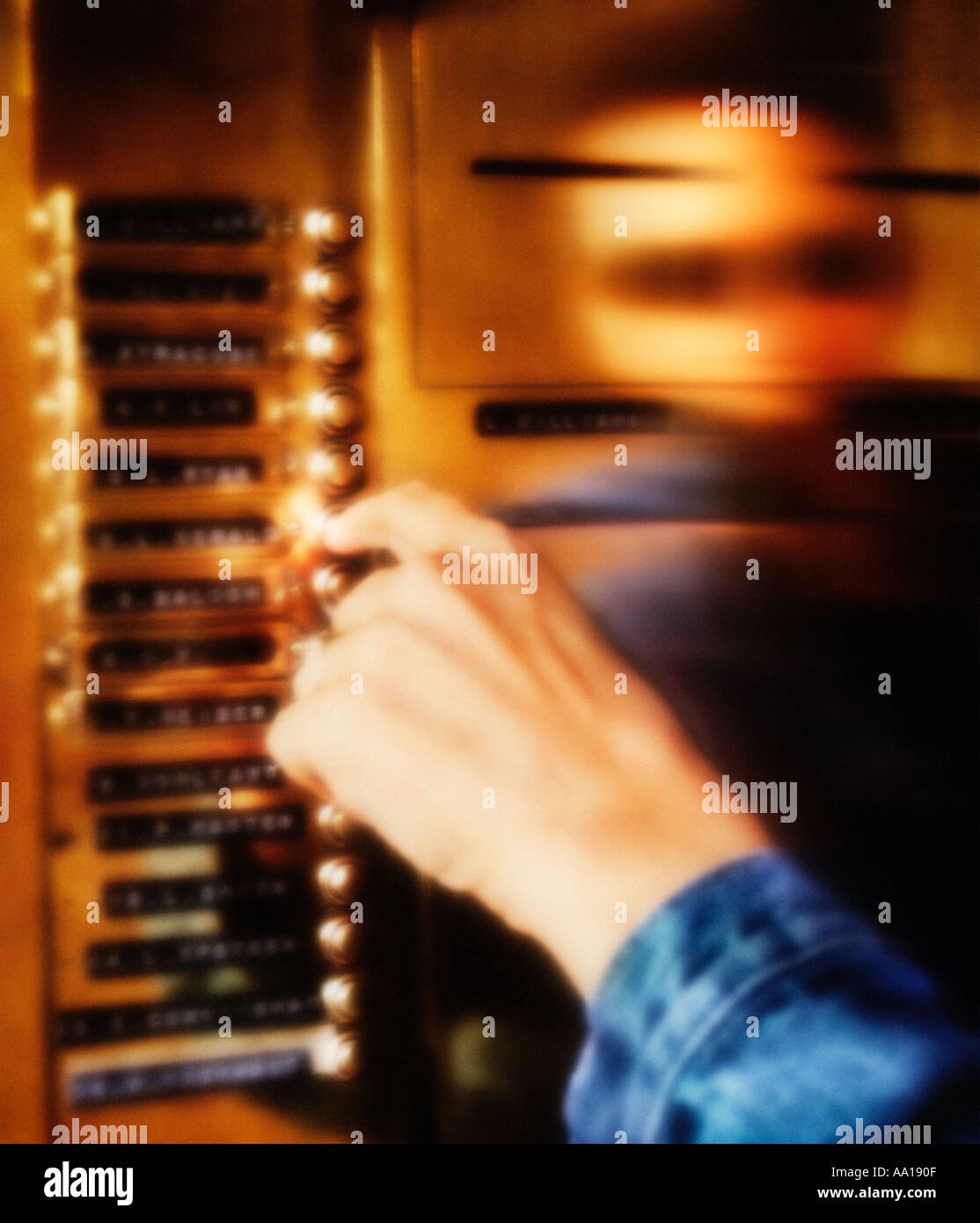 Close up of hand pushing apartment building intercom button with person ...