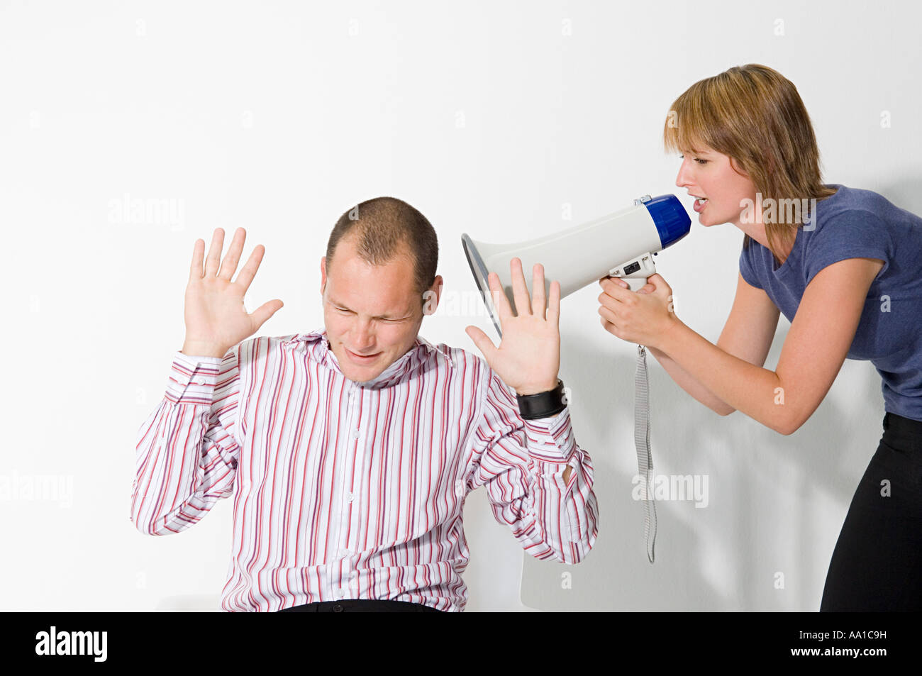 Man shouting at man through loudspeaker Stock Photo - Alamy