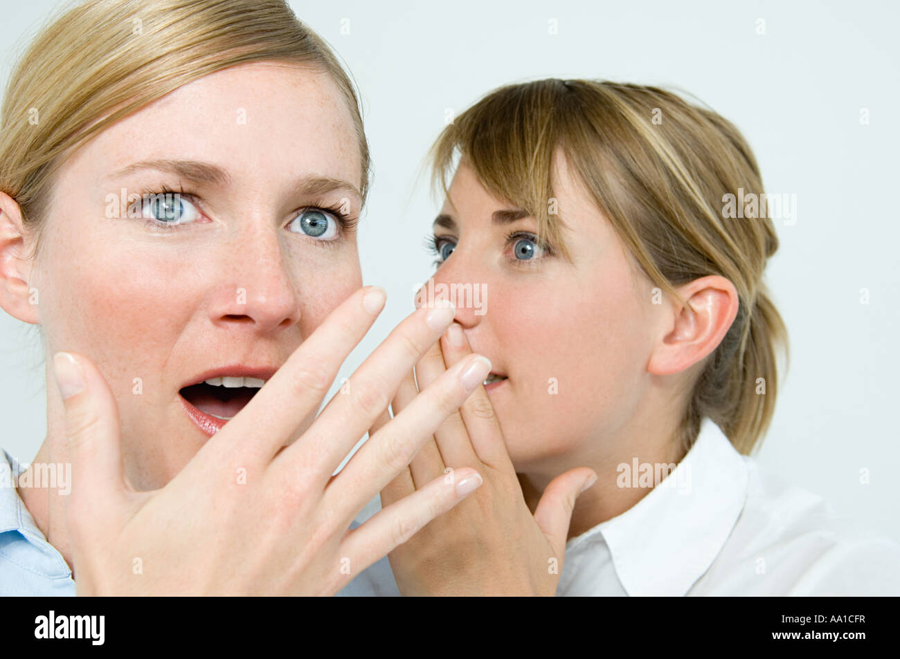 Two women gossiping Stock Photo - Alamy
