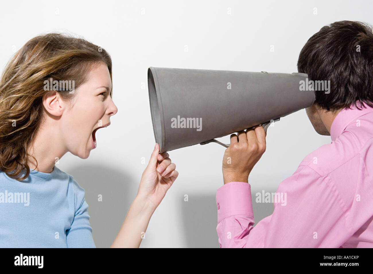 Woman shouting down megaphone Stock Photo - Alamy