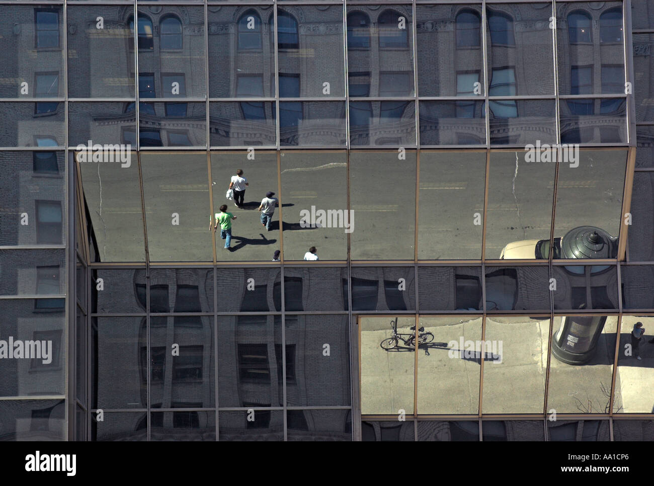 Angled windows in a Montreal building reflect both the building ...