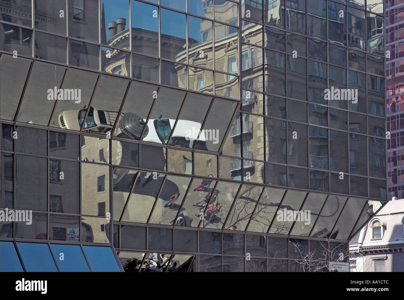 Angled windows in a Montreal building reflect both the building ...