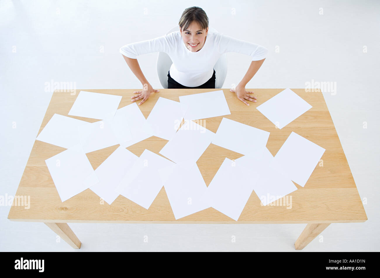 Woman with desk of paper work Stock Photo - Alamy