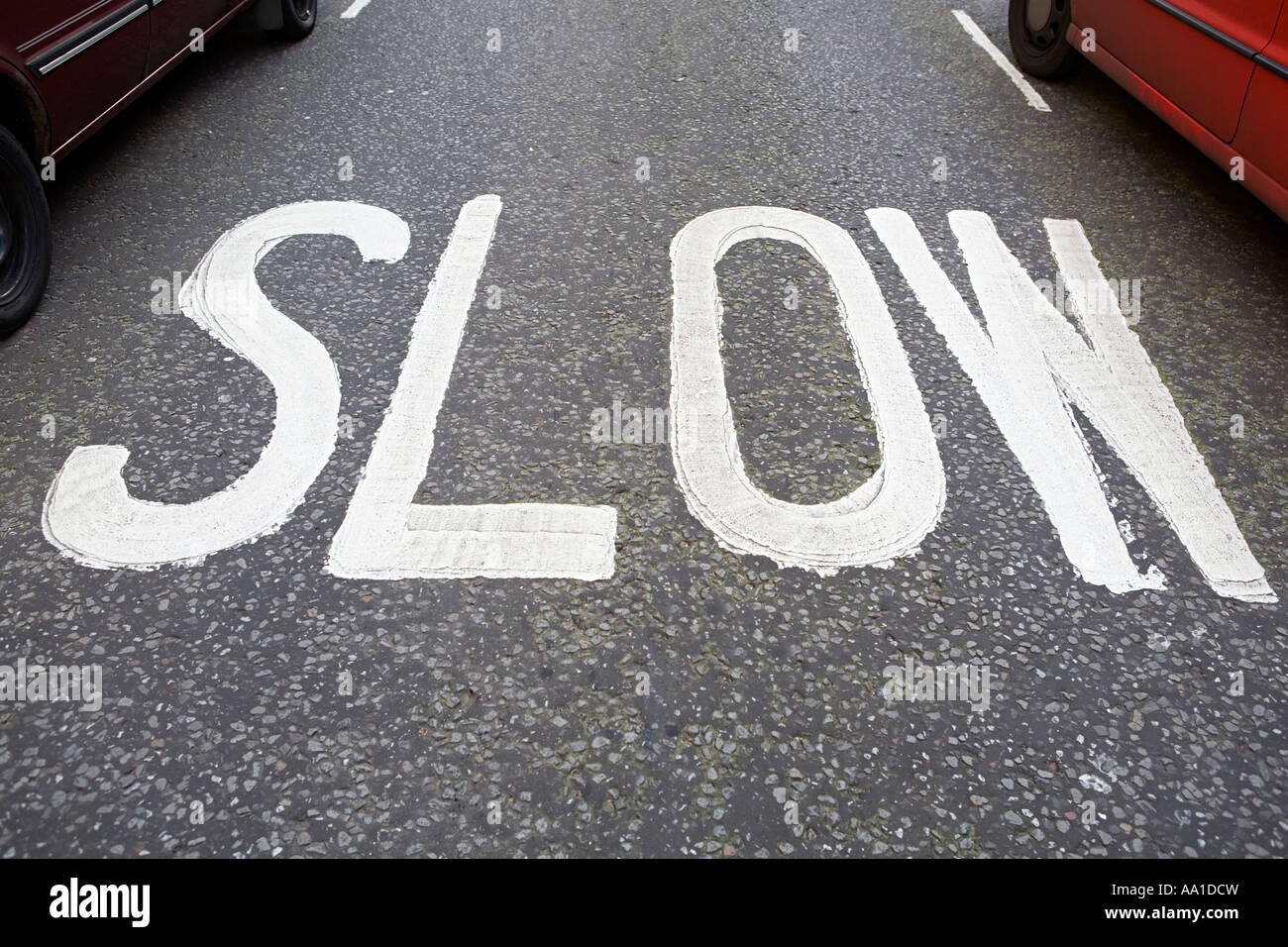 Slow road marking Stock Photo - Alamy