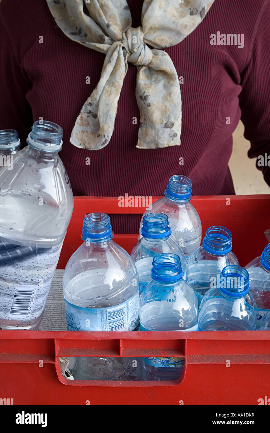 Person holding plastic bottles Stock Photo - Alamy