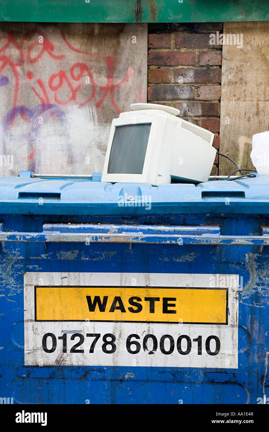 Computer monitor on top of skip Stock Photo - Alamy