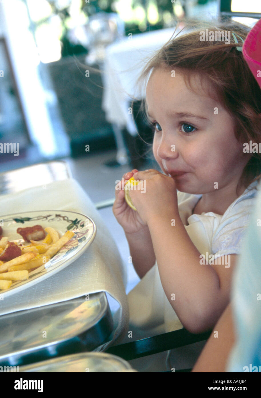 Young girl puckering up her lips after sucking a lemon Stock Photo - Alamy