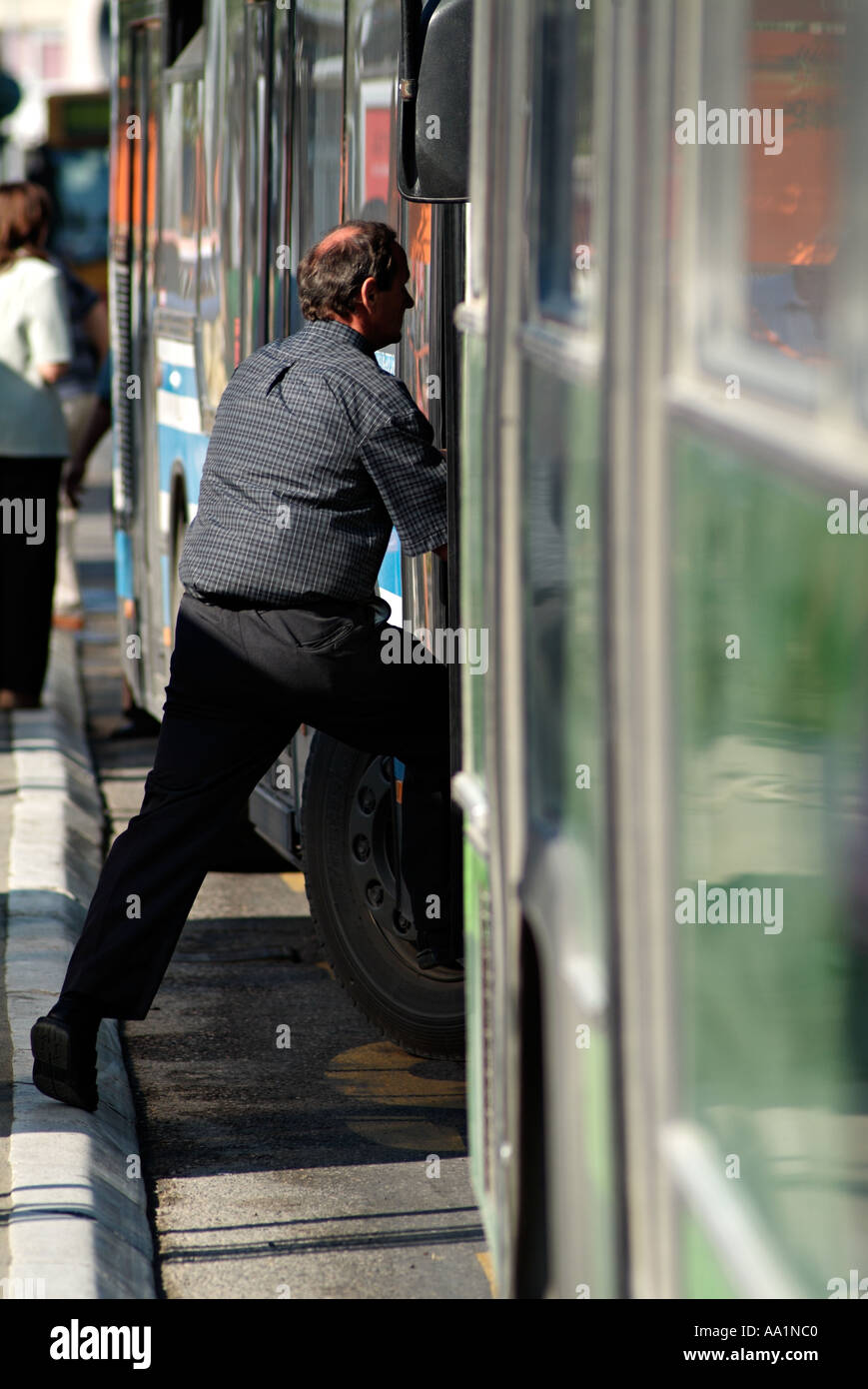 Man Getting On a Bus Stock Photo - Alamy