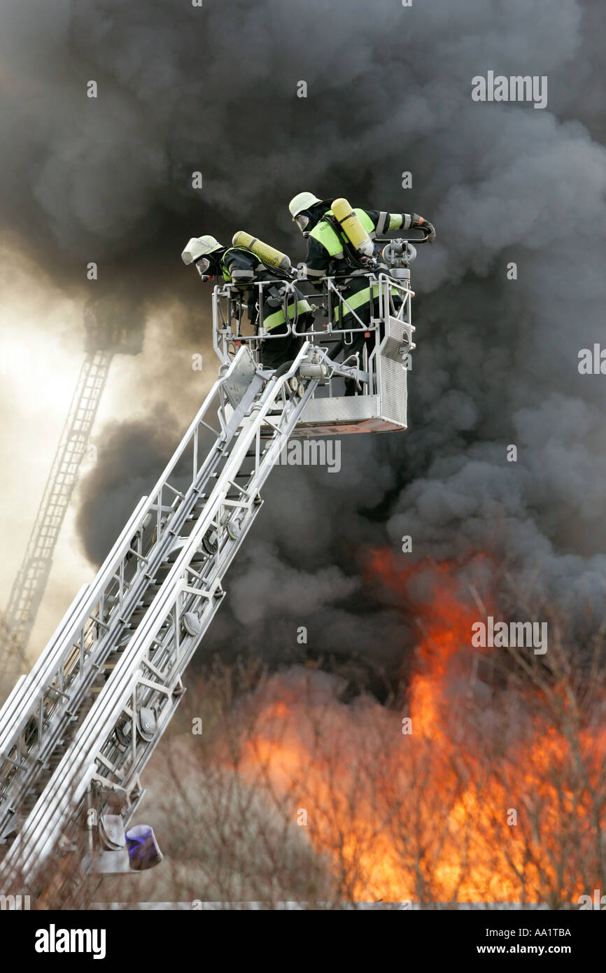 German fire brigade men fights a blaze in a warehouse in Munich Bavaria ...