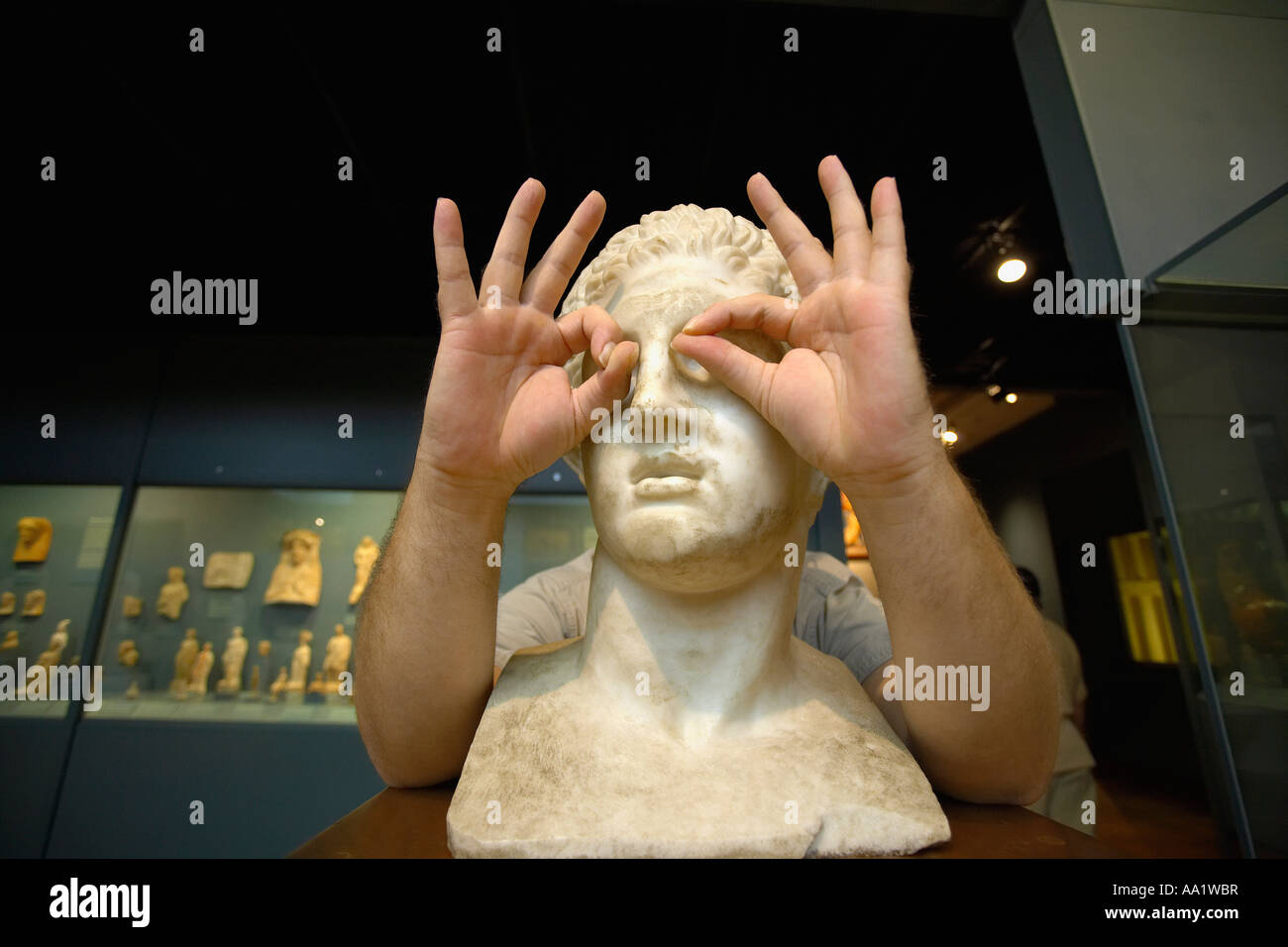 Man Making Glasses with Hands on Statue Stock Photo - Alamy