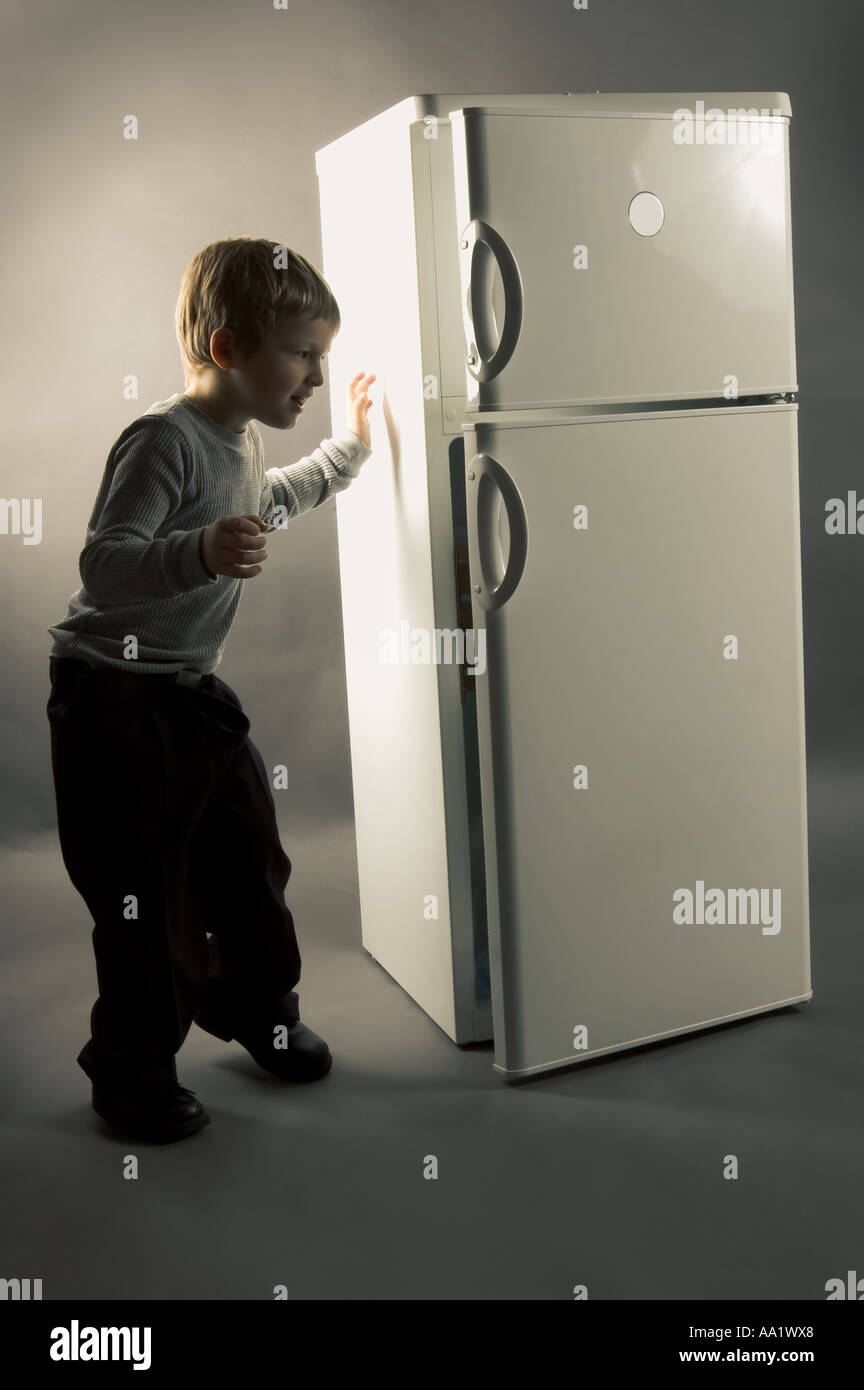 Little boy by the refrigerator Stock Photo - Alamy