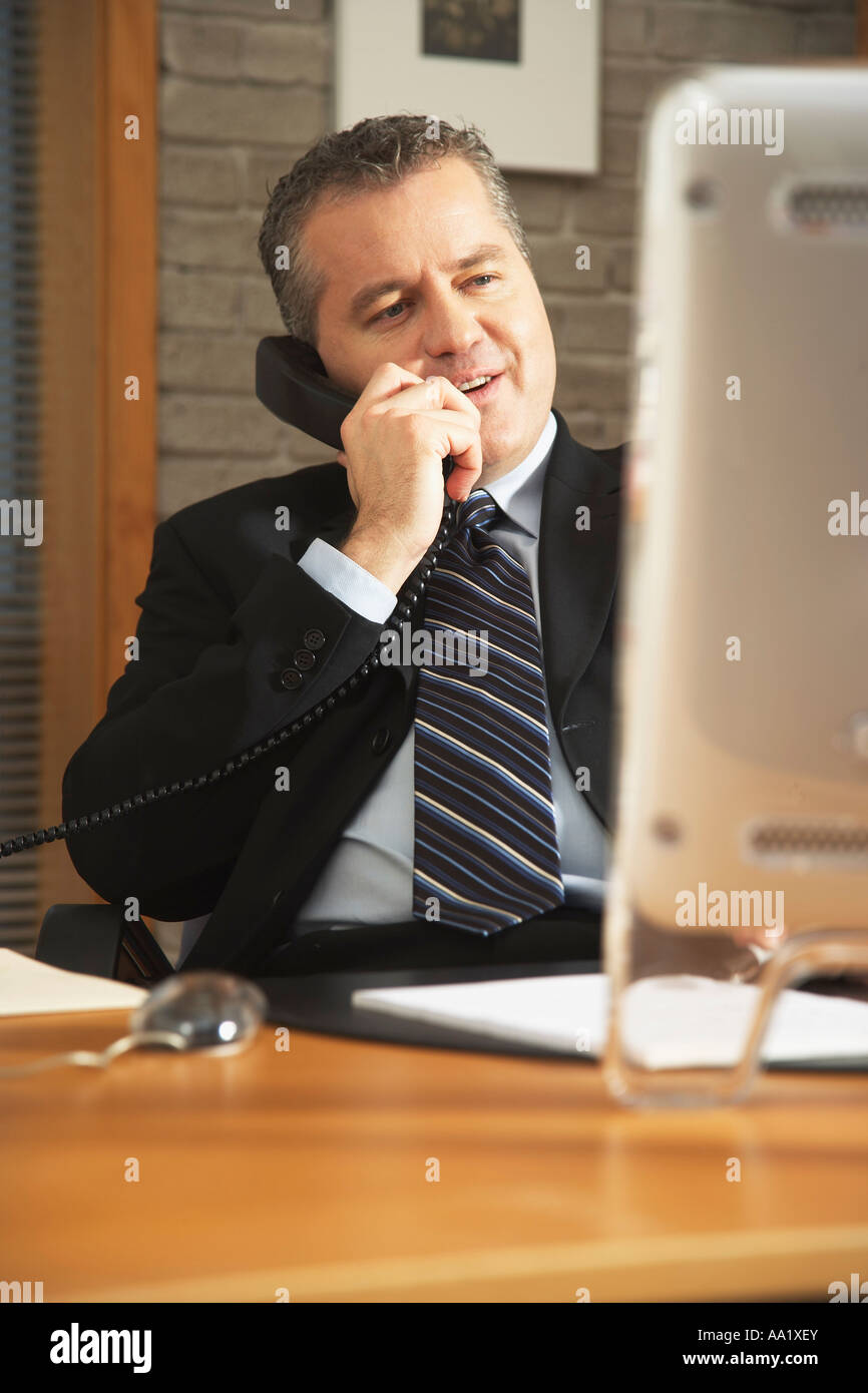 Businessman Using Telephone Stock Photo - Alamy