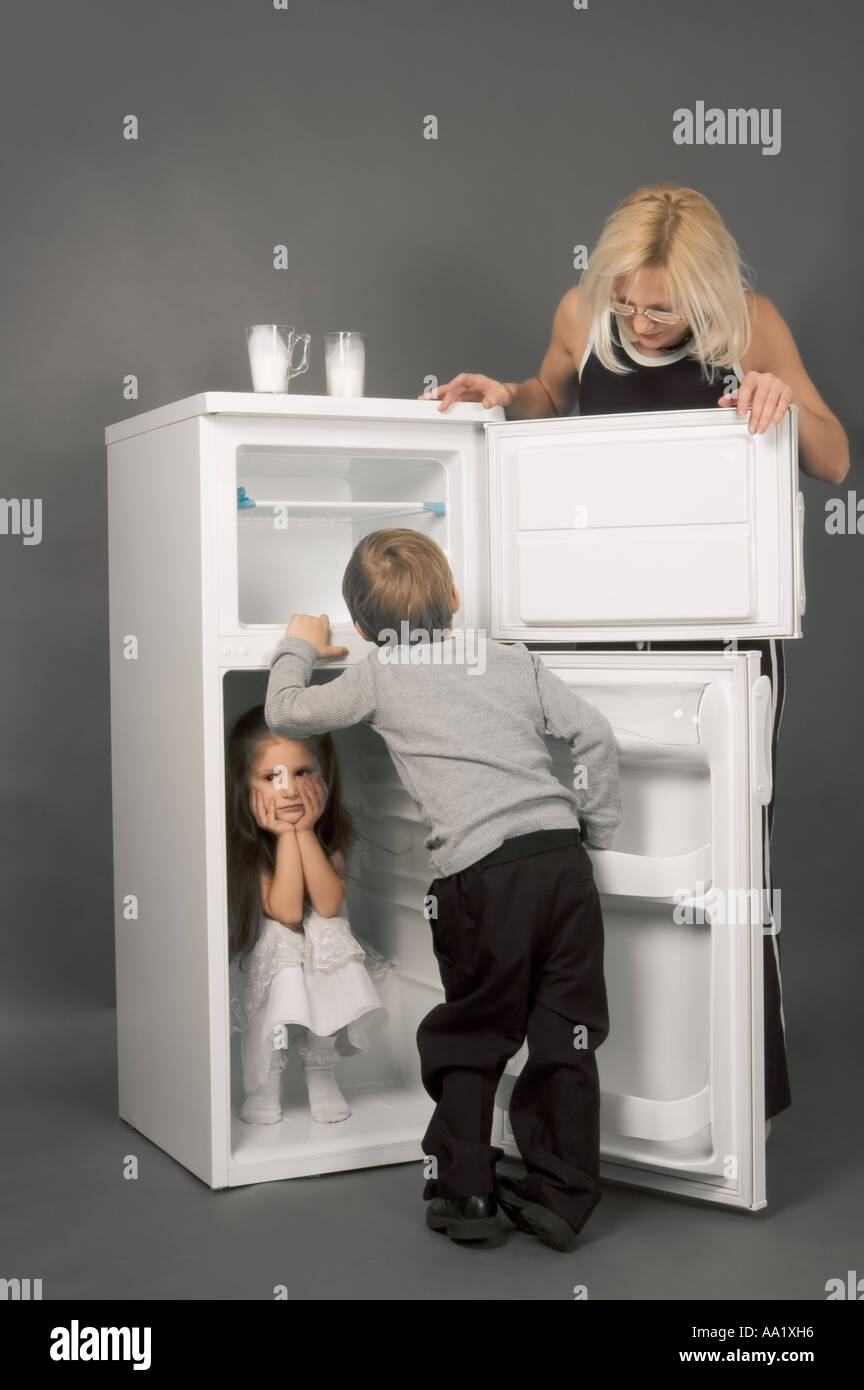 People in and by the refrigerator Stock Photo - Alamy