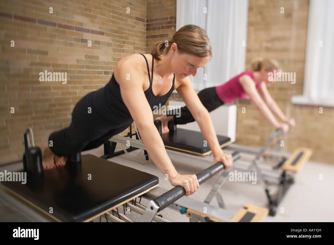 Women on Pilates Exercise Machines Stock Photo - Alamy