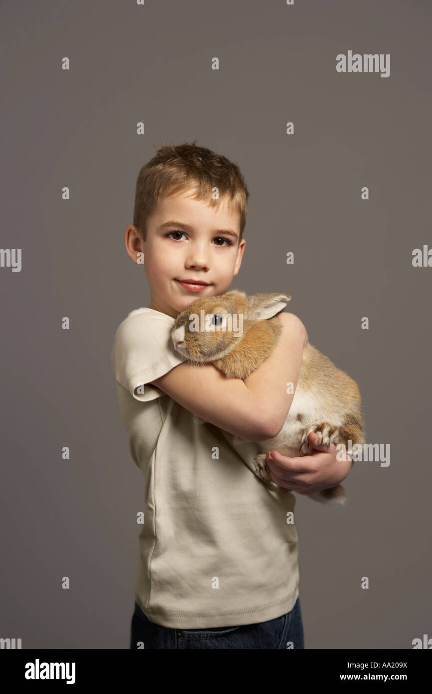 Portrait of Boy Holding Rabbit Stock Photo - Alamy