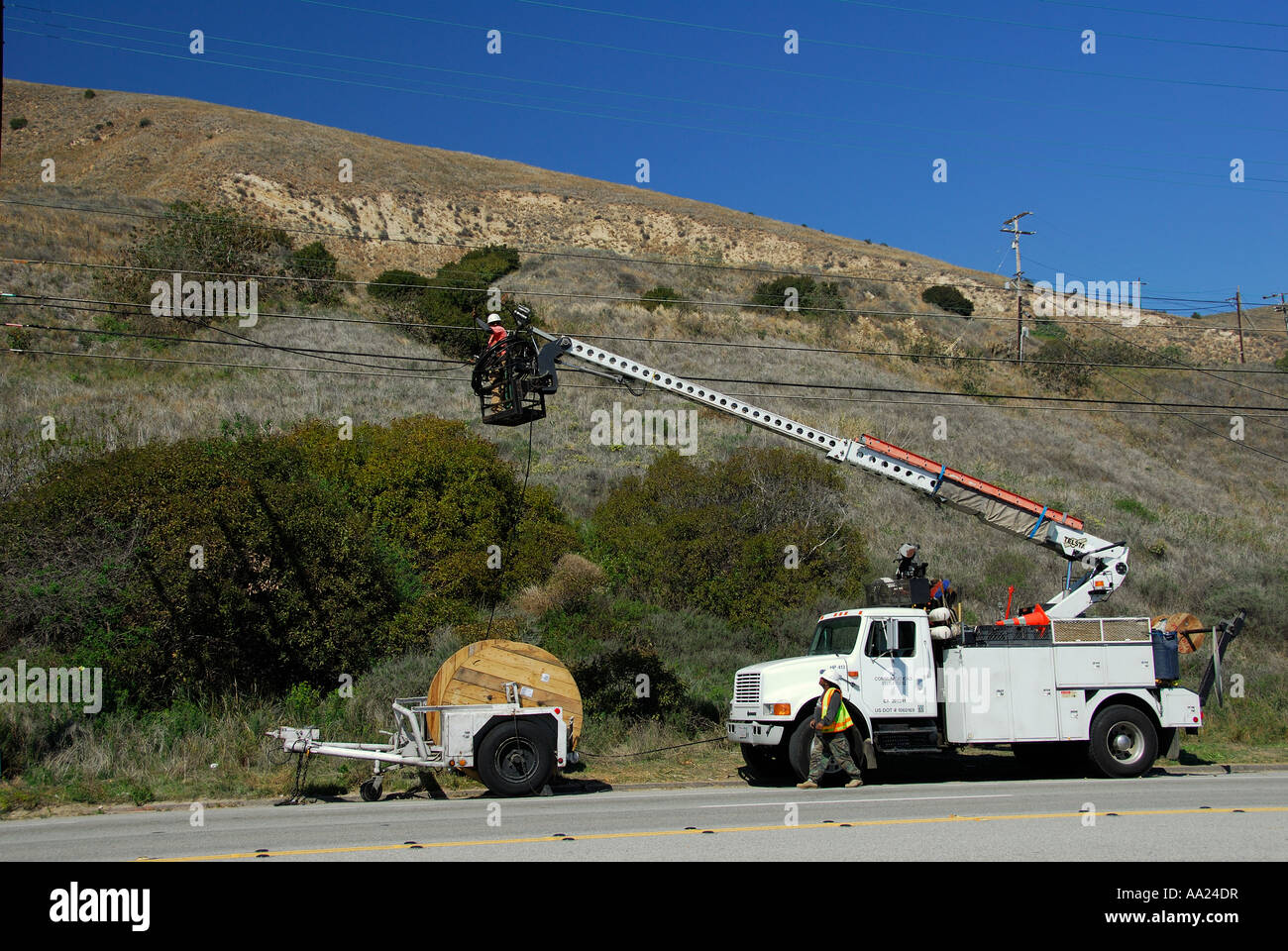 Telecom engineers maintaining power / cable TV wires Stock Photo - Alamy