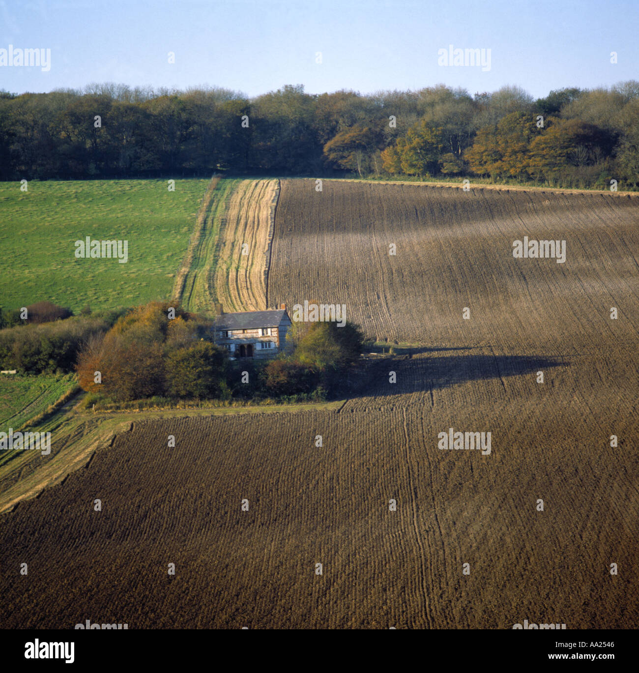 Looking down on four fields three of which are fallow and ploughed ...