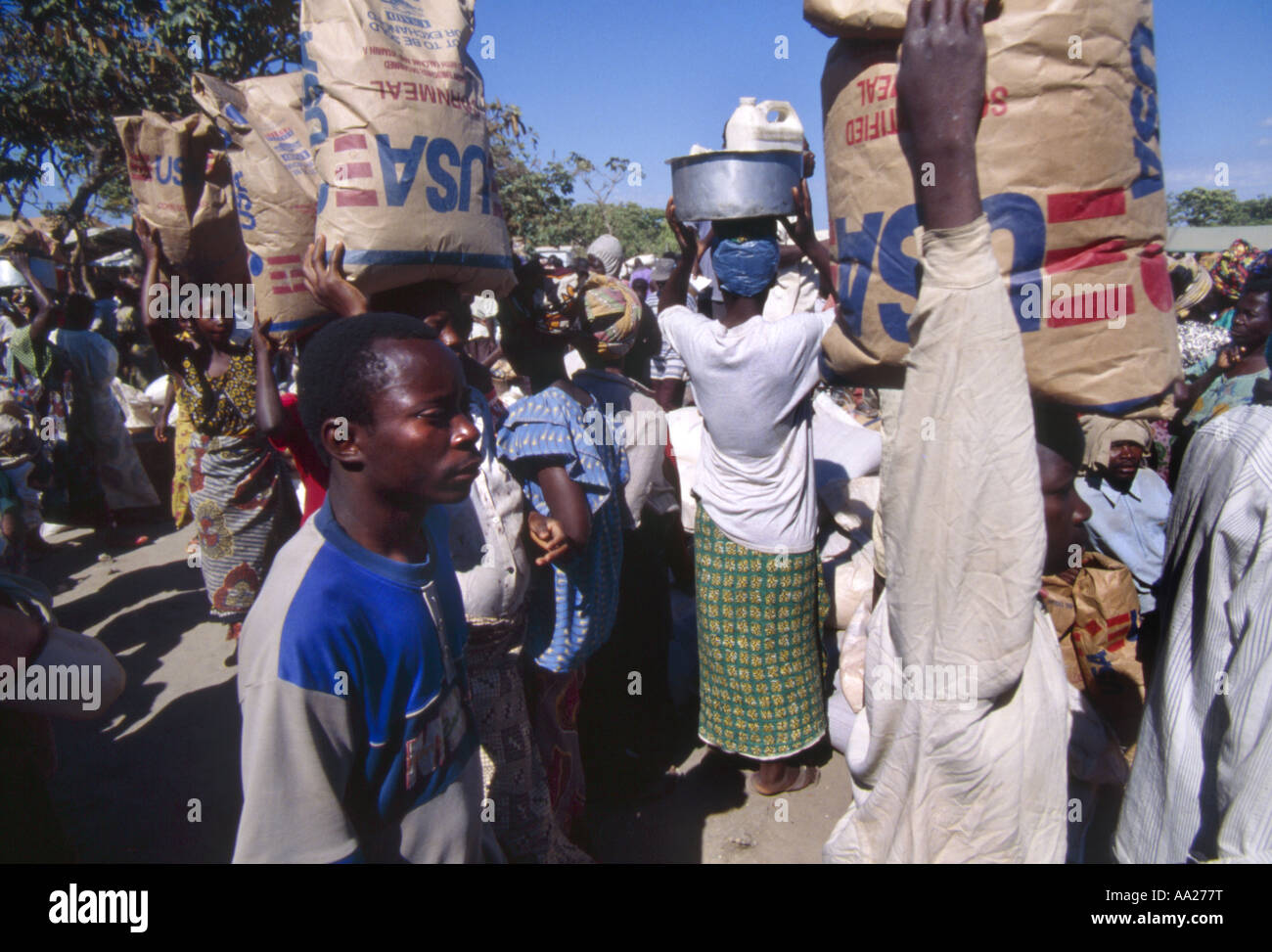 Refugees collect handouts at the distribution centre, Lugufu refugee ...