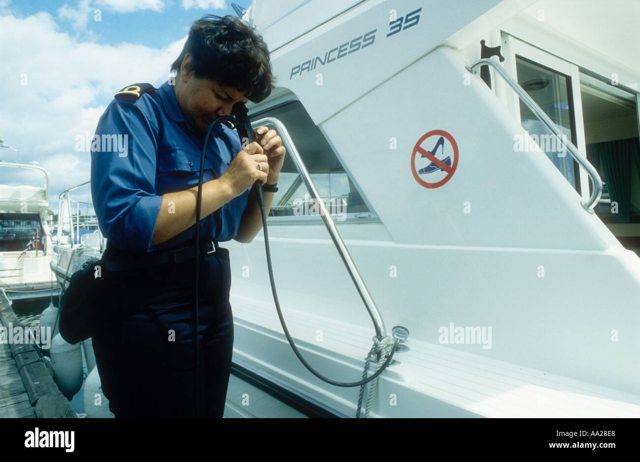 A Customs and Excise officer uses an endoscope to check a cruiser water ...