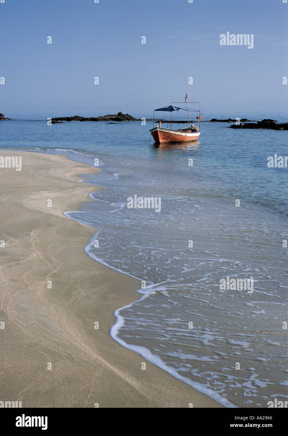 fishing boat anchored off beach in north cyprus Stock Photo - Alamy