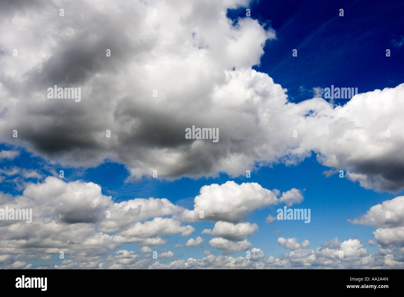 Blue sky with fluffy white clouds Stock Photo - Alamy
