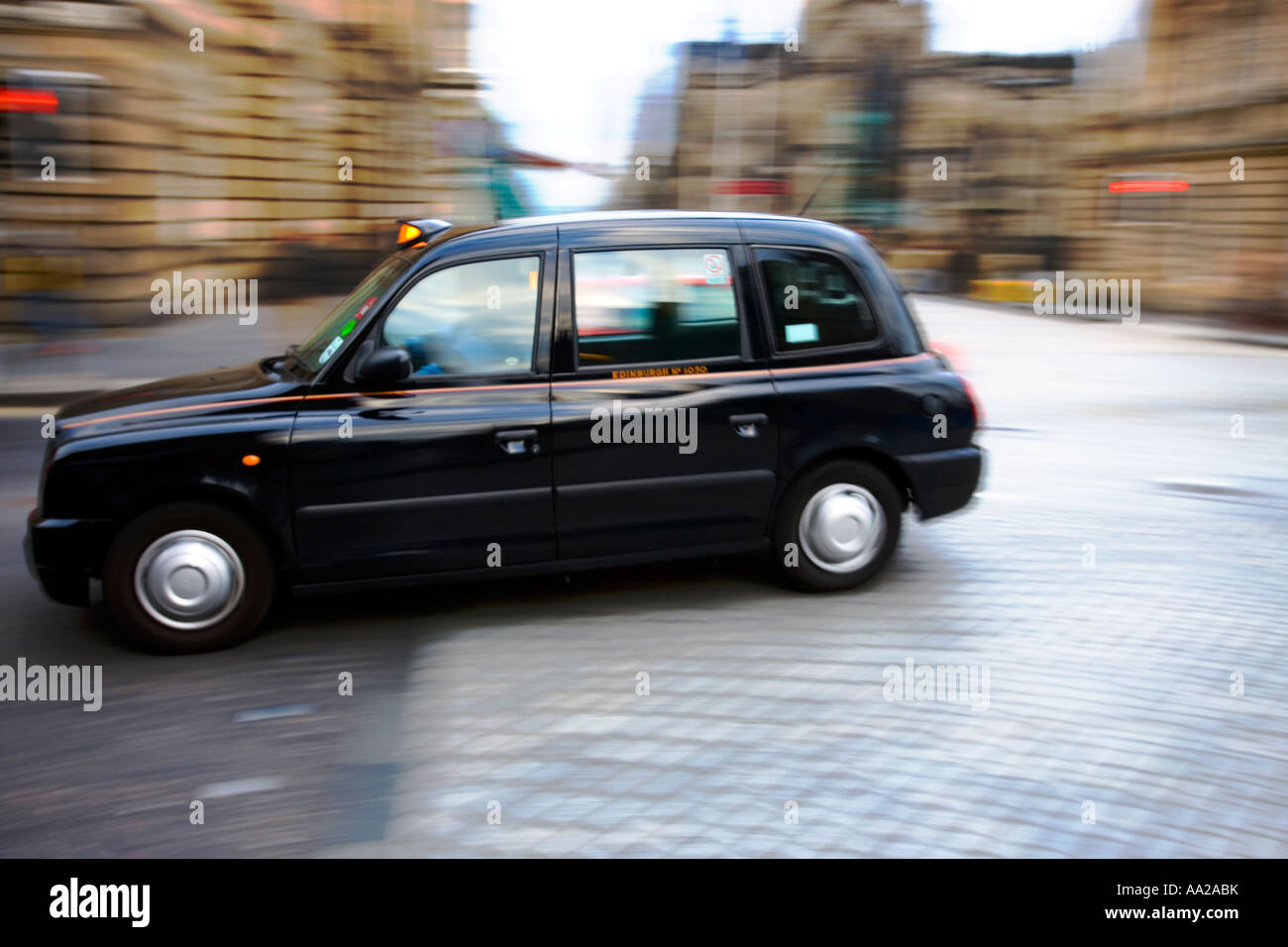 Edinburgh city centre black cab taxi panning Stock Photo - Alamy