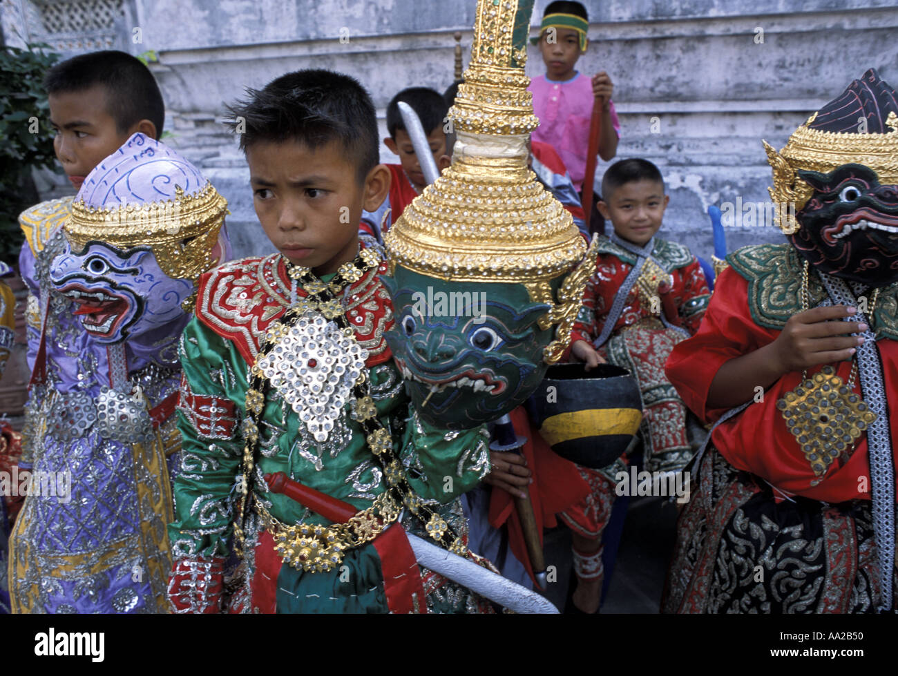 Bangkok: Boys take a break from wearing their heavy "khon" (masks) the ...