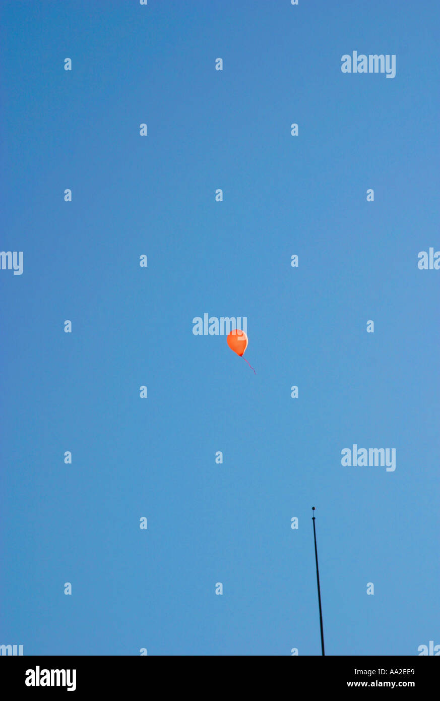 Single bright orange balloon in flight Stock Photo - Alamy