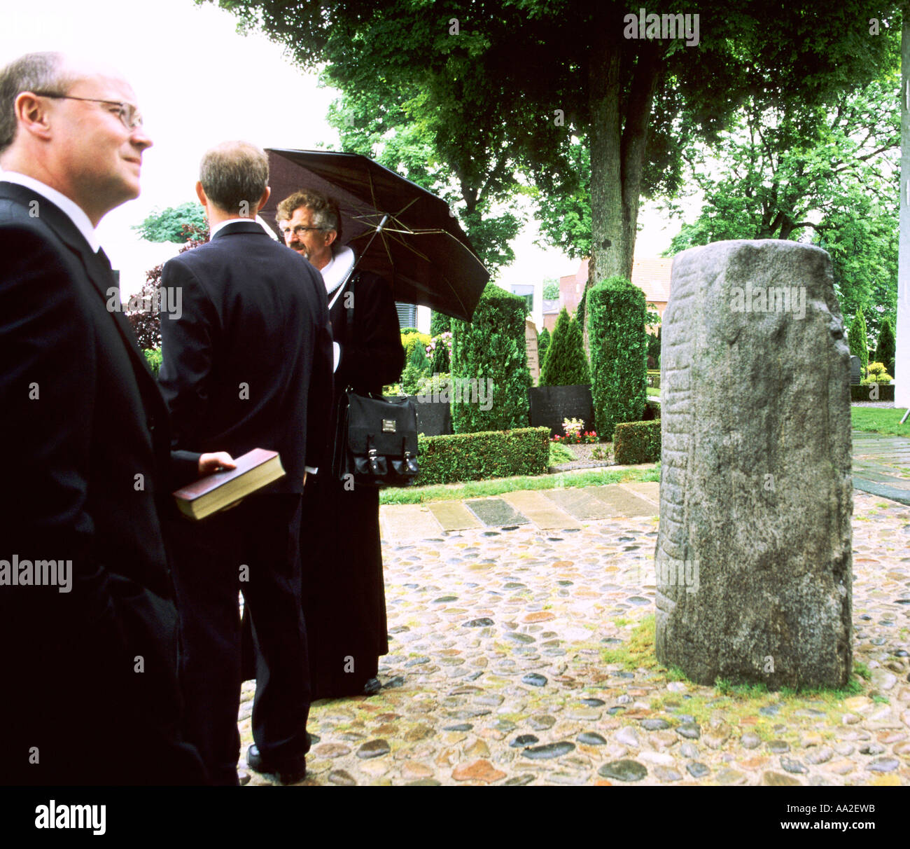Denmark, Jellinge, people standing by rune stone Stock Photo - Alamy