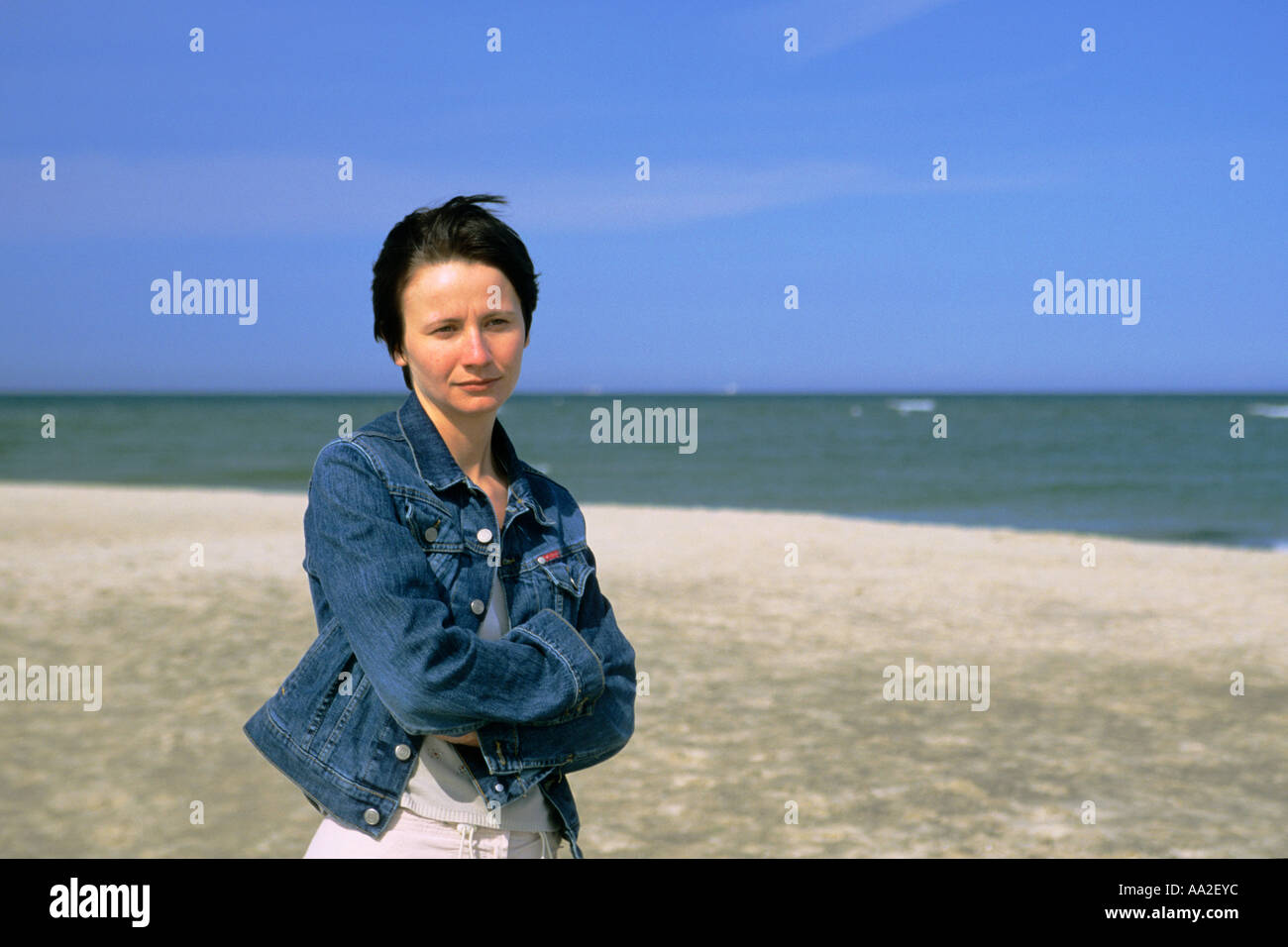 Denmark, woman standing on beach, portrait Stock Photo - Alamy