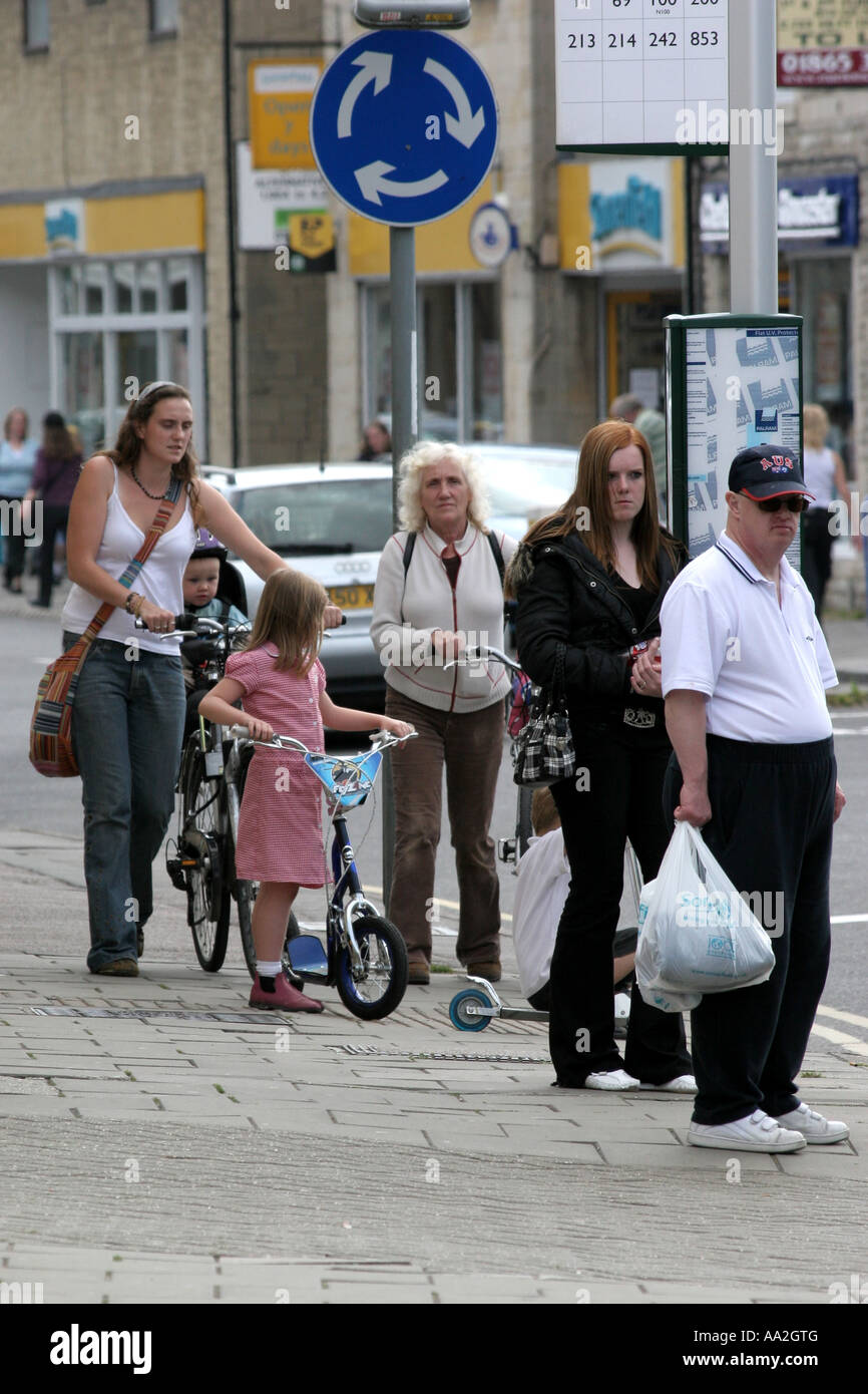 People stood at a bus stop in Witney Oxfordshire Stock Photo - Alamy