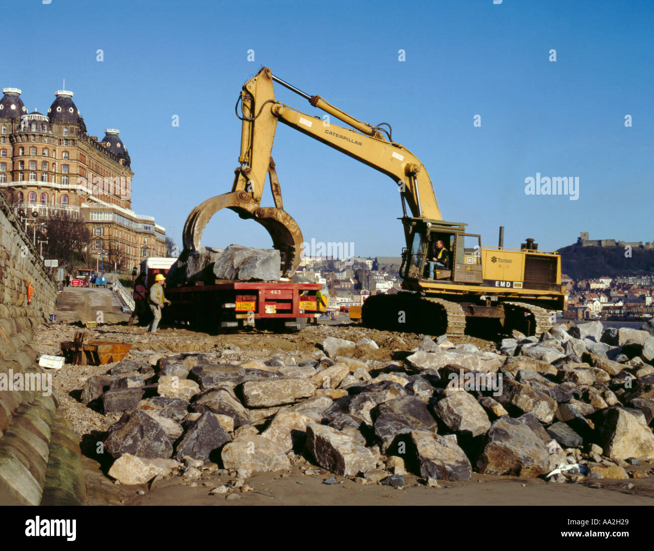 Placing boulder protection to the base of a cliff, Scarborough, North ...