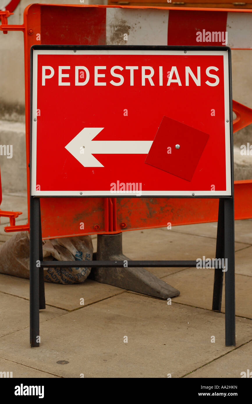 Pedestrians sign with arrow direction pointer at construction site ...