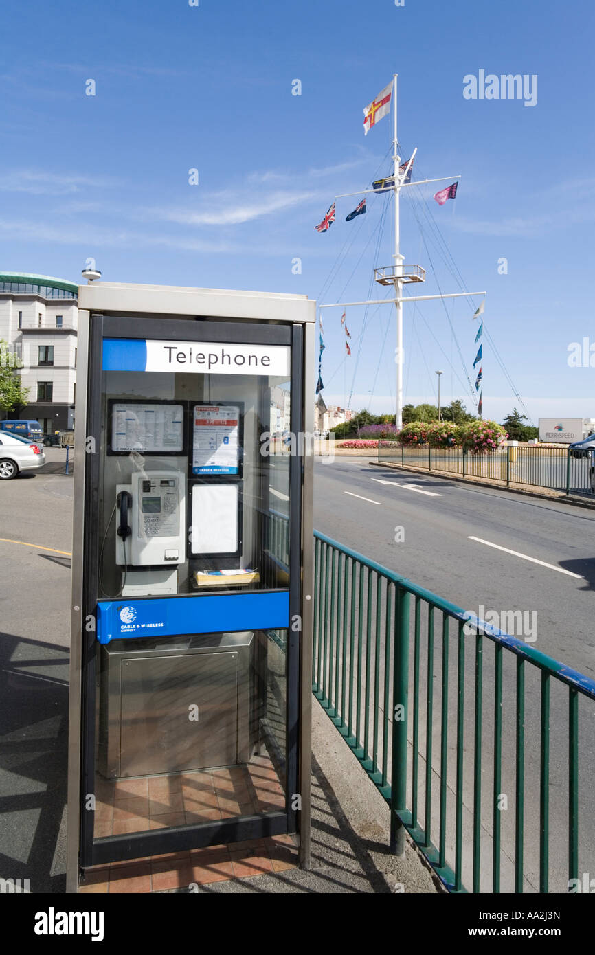 A blue public telephone box on the North Esplanade, St Peter Port ...