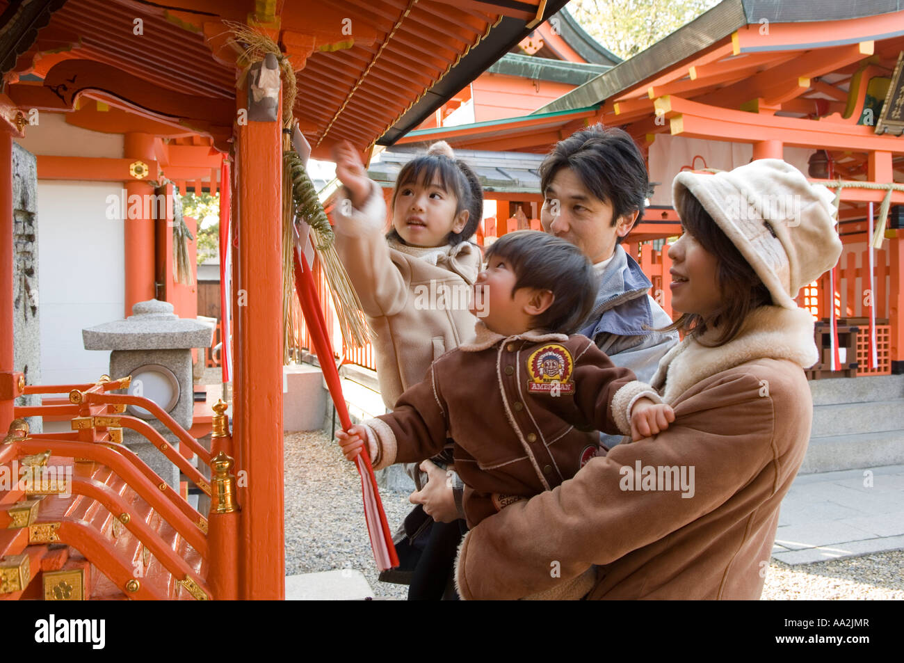 Family at shrine Stock Photo - Alamy