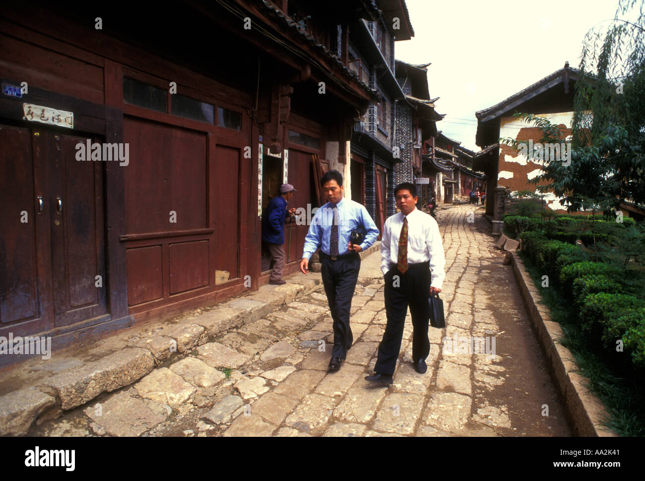 2 two Chinese people person males men businessmen strolling in the Old ...