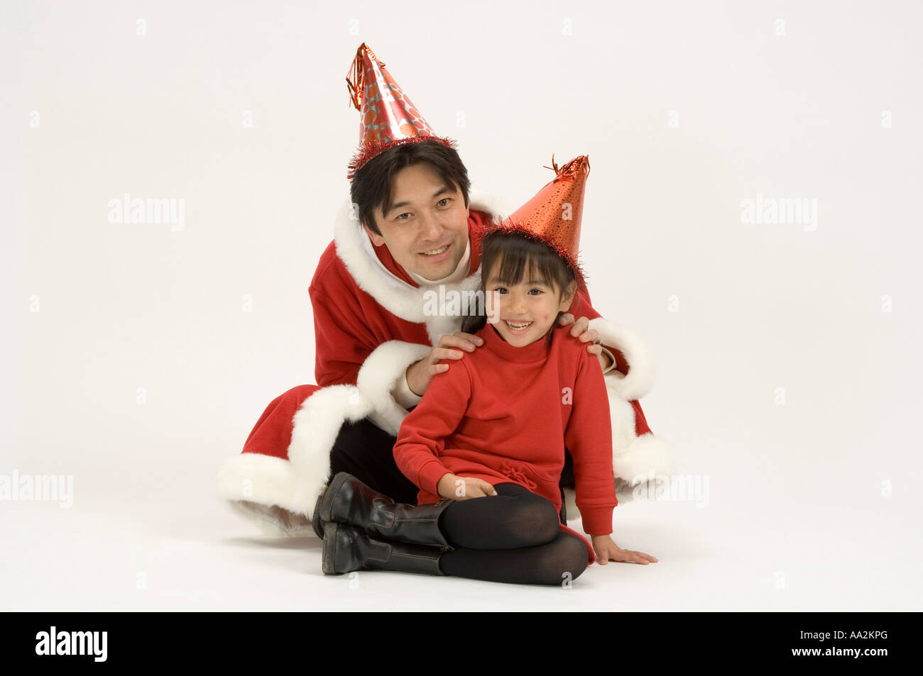 Father in Santa outfit sitting with daughter Stock Photo - Alamy