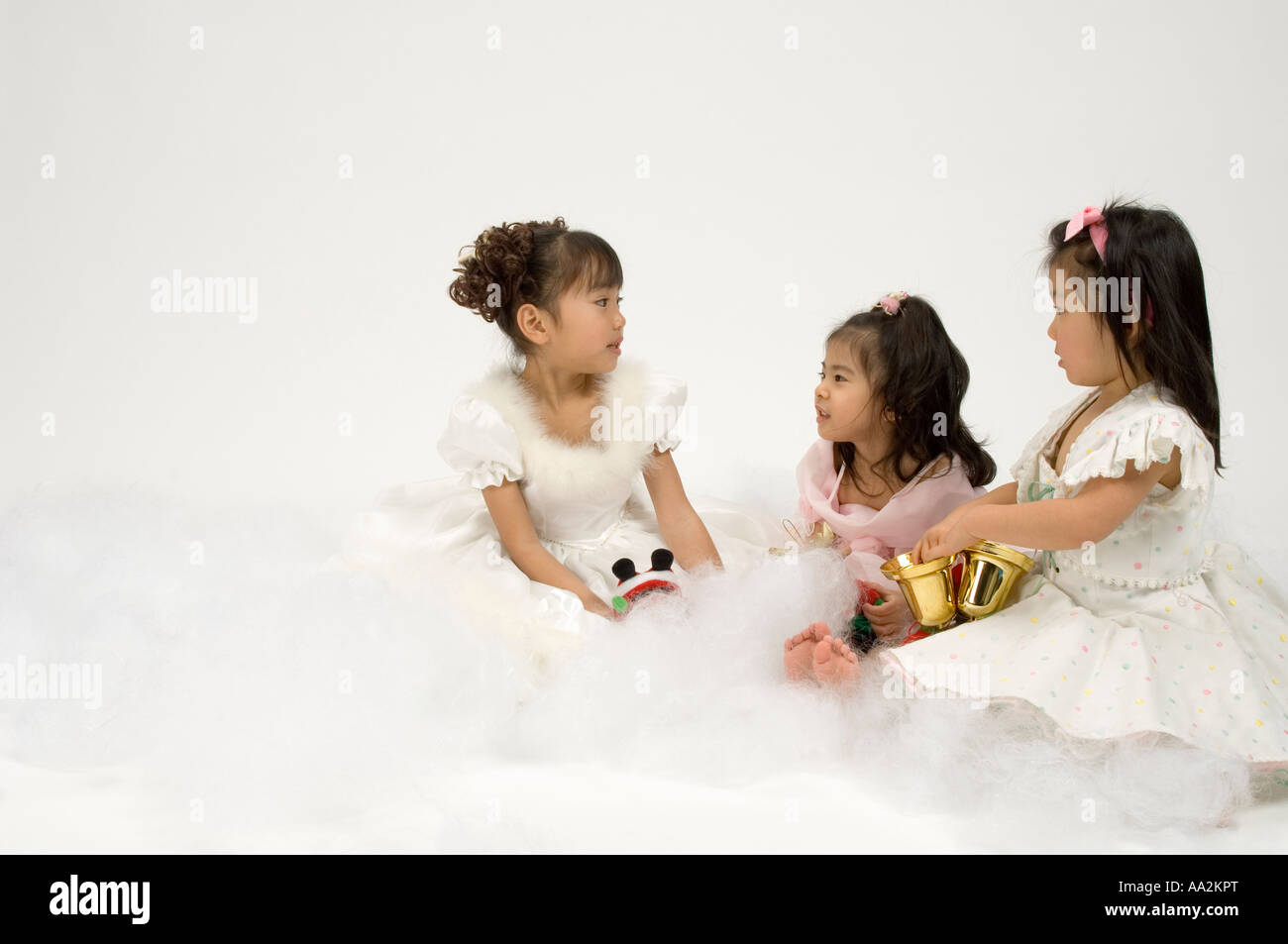 Three girls wearing dresses Stock Photo - Alamy