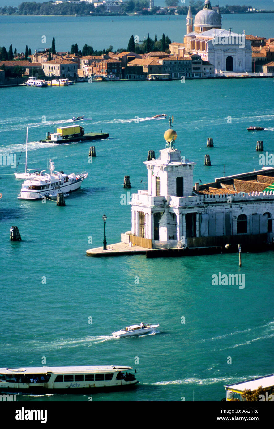 Italy, Venice, small church by lagoon, water traffic passing, elevated ...