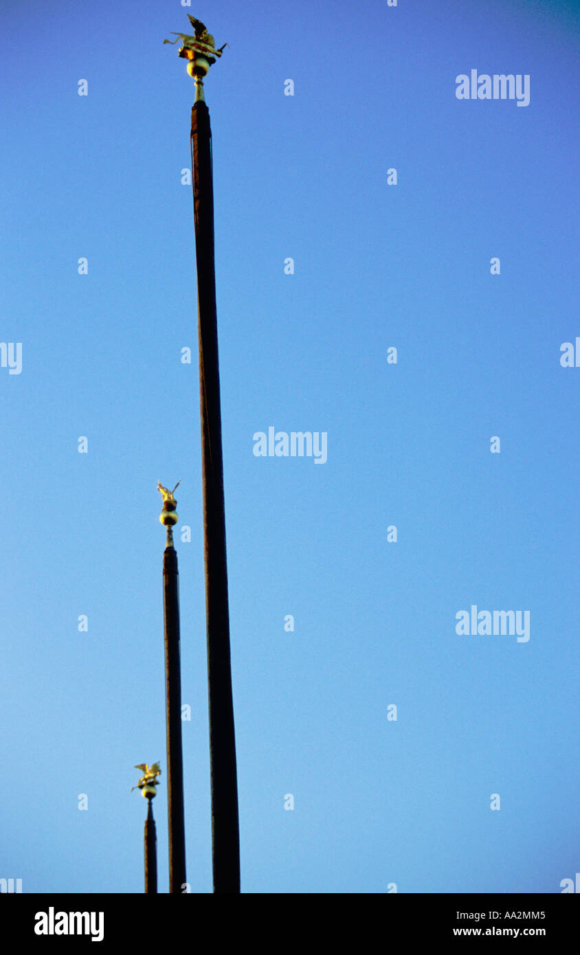 Italy, Venice, black poles with gilded winged lion tops, blue sky ...