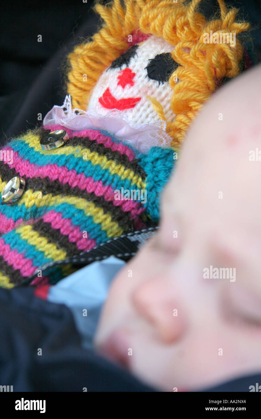 baby boy sleeping next to clown doll Stock Photo - Alamy