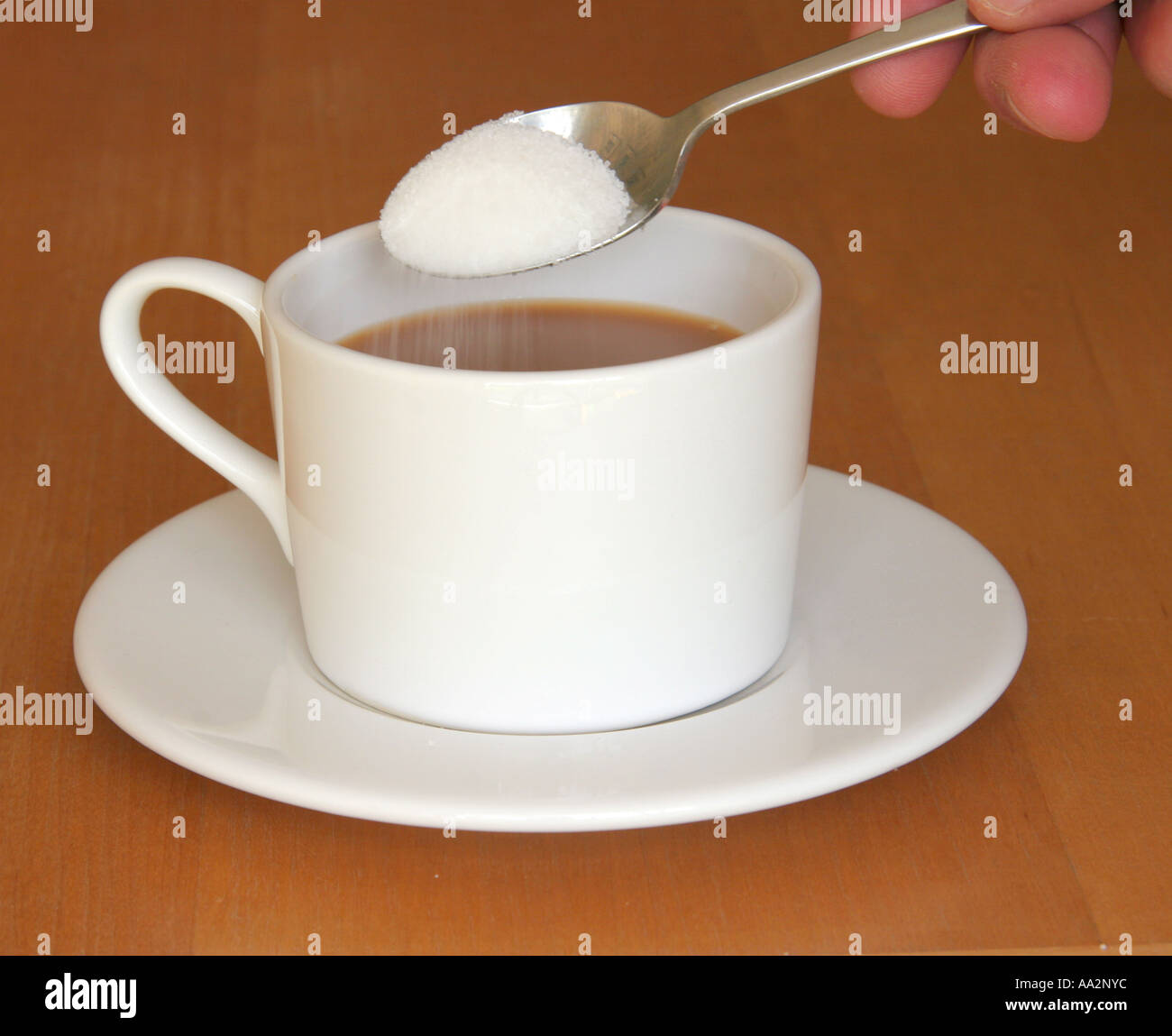spooning sugar into a cup of tea Stock Photo - Alamy