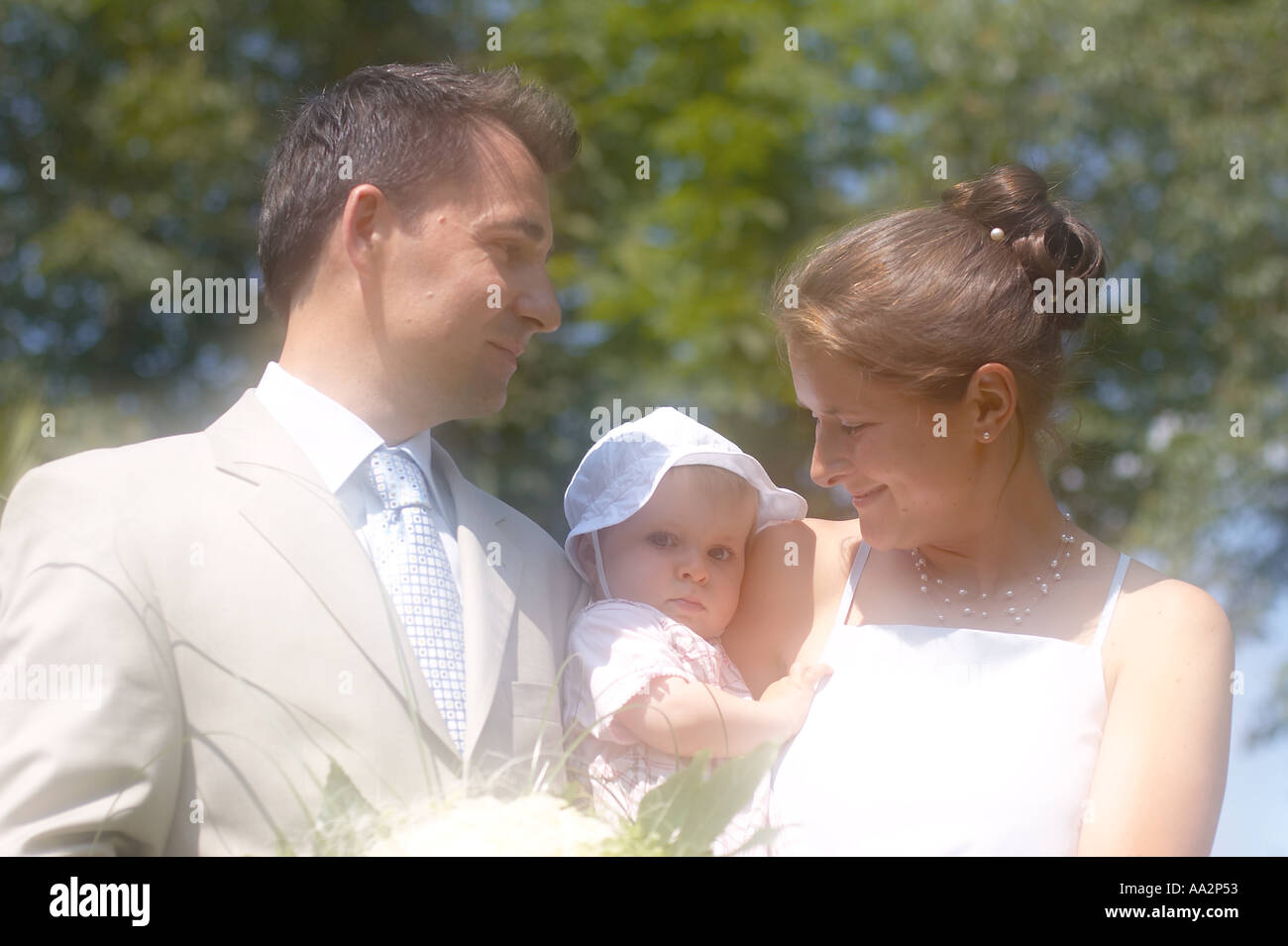 bridal couple with baby Stock Photo - Alamy