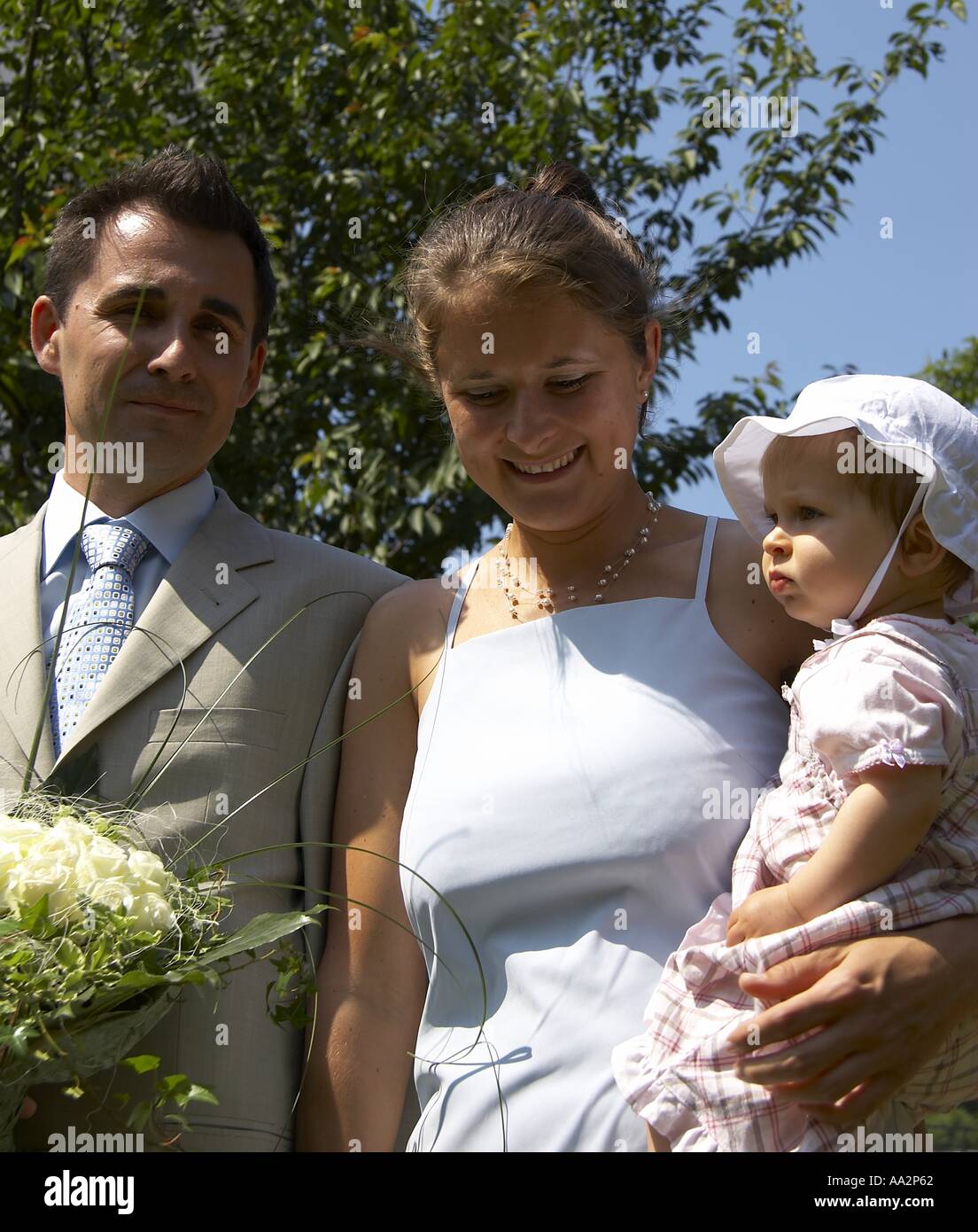 bridal couple with baby Stock Photo - Alamy