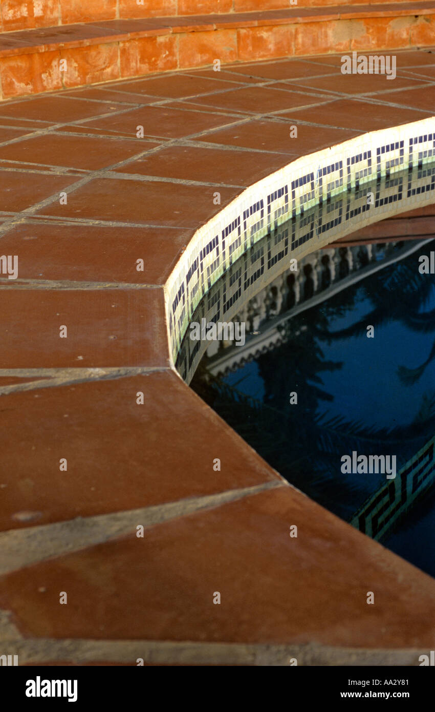swimming pool with terracotta tiles surround in garden of villa in ...