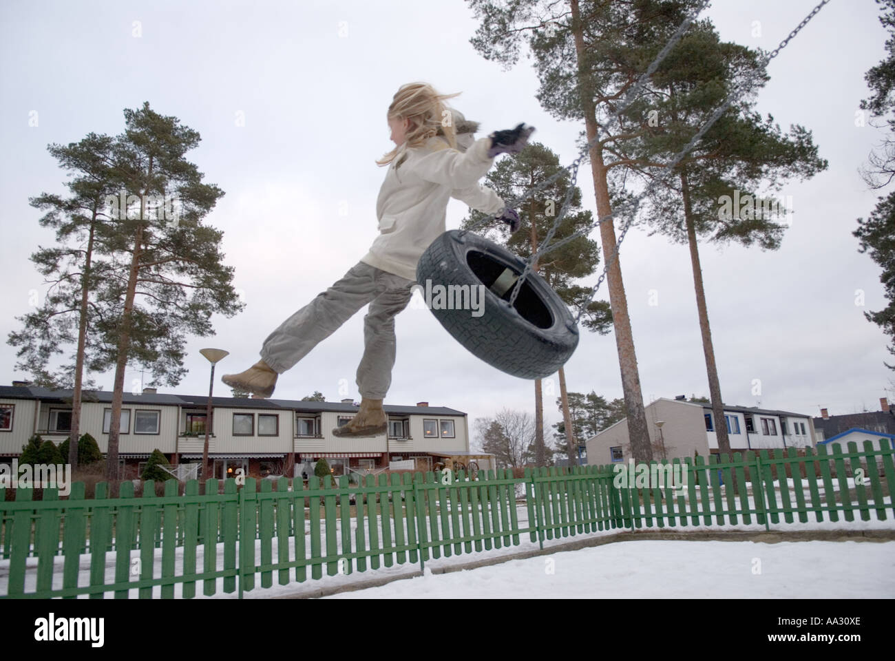 Girl jumping from swing Stock Photo - Alamy