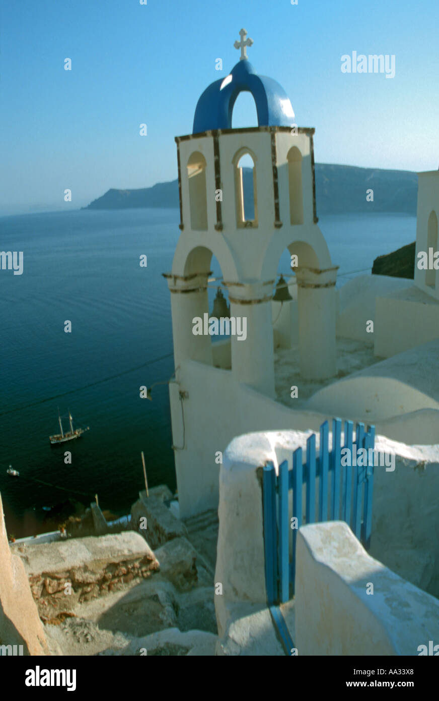 Greece Santorini Ia blue and white church steeple overlooking the sea ...