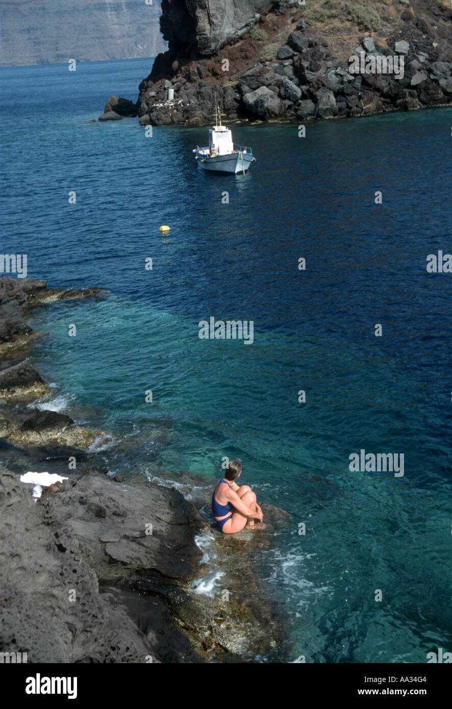Greece Aegean sea Santorini bathing woman with fishing boat in ...