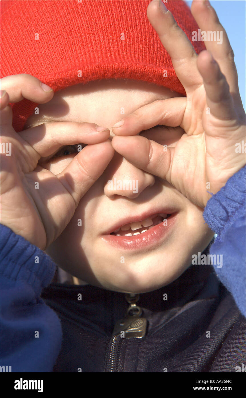 Fingers in front of a face Stock Photo - Alamy