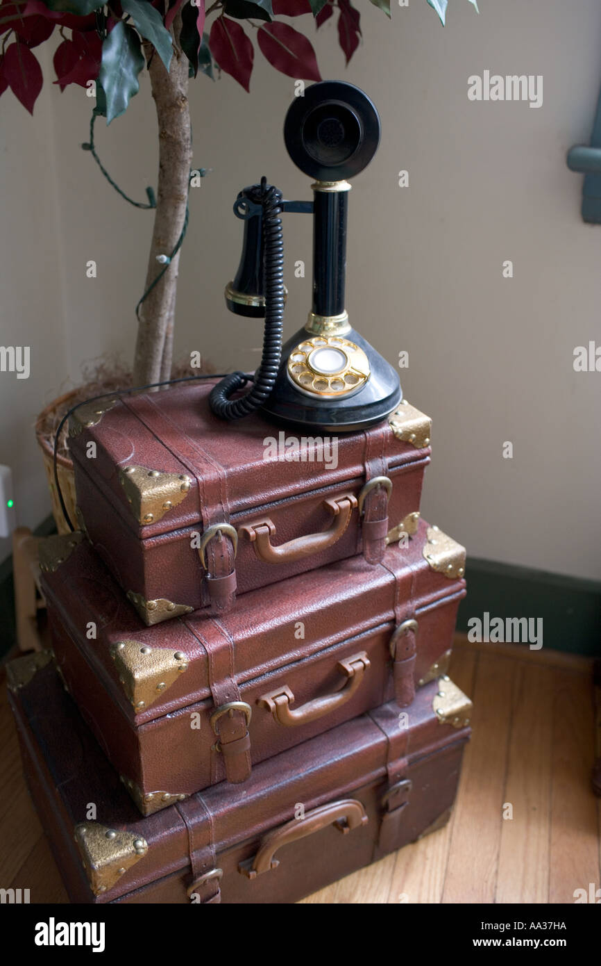 Old phone with antique suitcases Stock Photo - Alamy